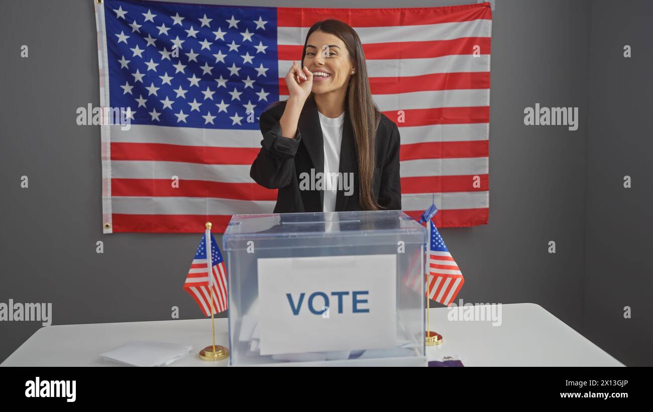 Young hispanic woman smiling in a voting room with american flags ...