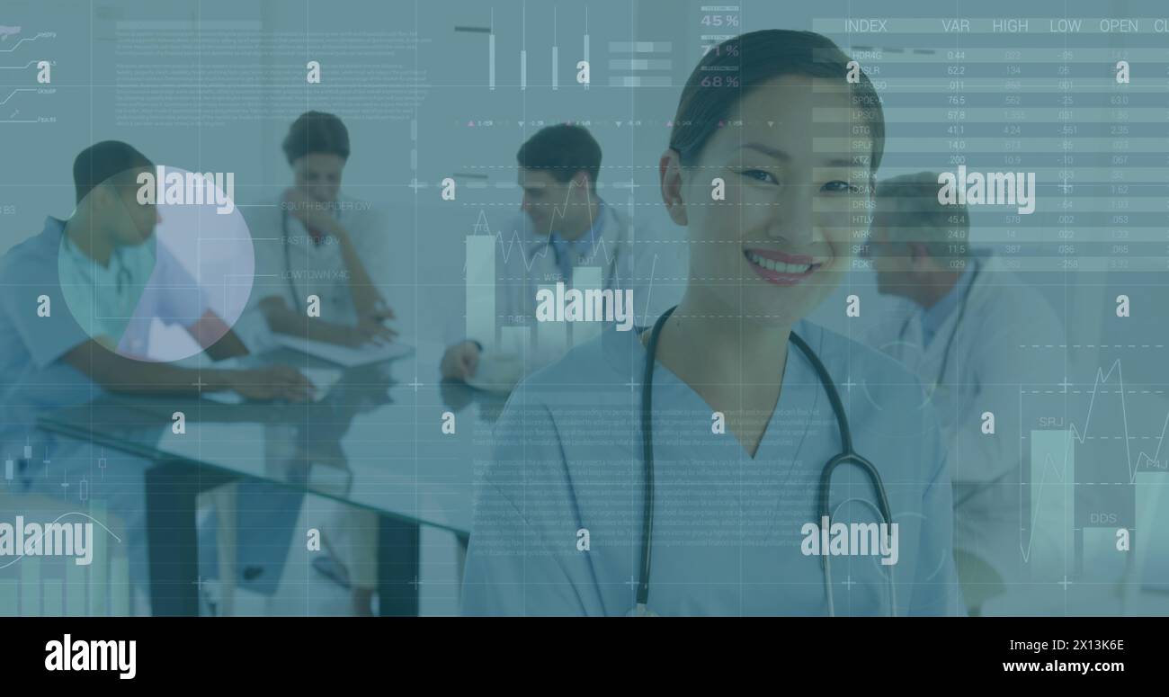 Image of graphs and data over happy biracial female doctor and diverse ...