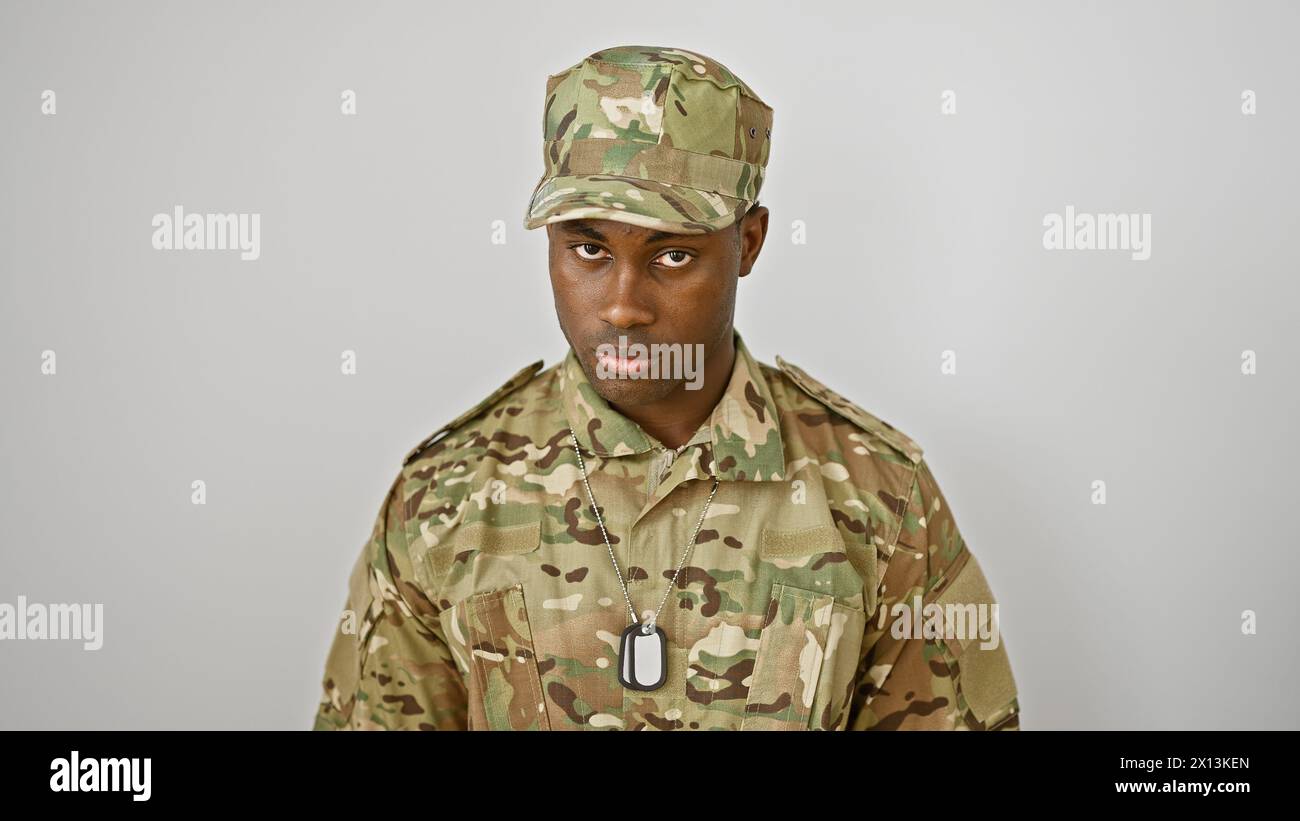 Portrait of a young adult man in military uniform against a white ...