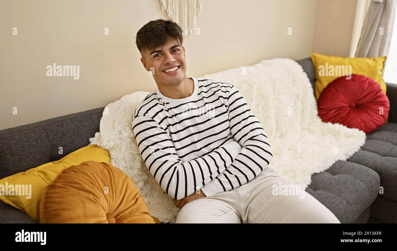 Radiant young hispanic man exudes confidence as he rests comfortably on ...