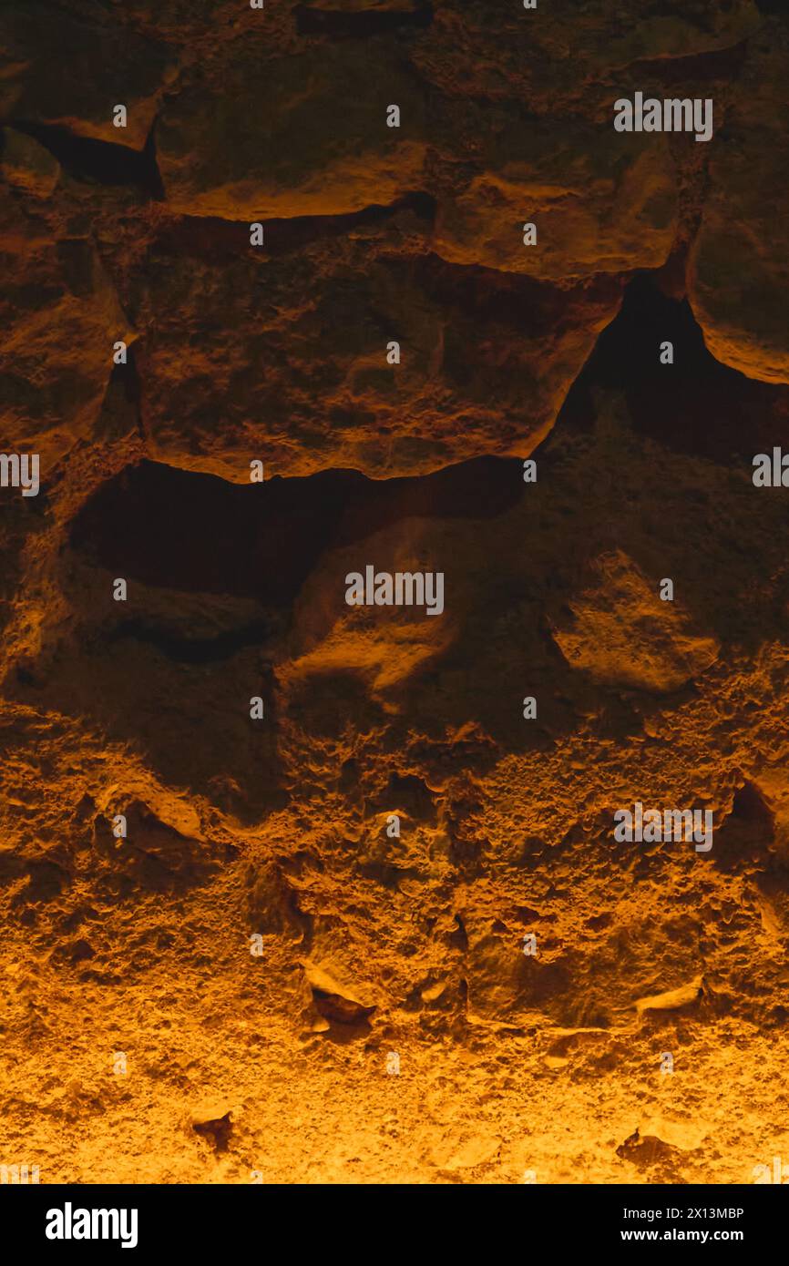 A breathtaking view of an illuminated cave showcasing unique rock ...