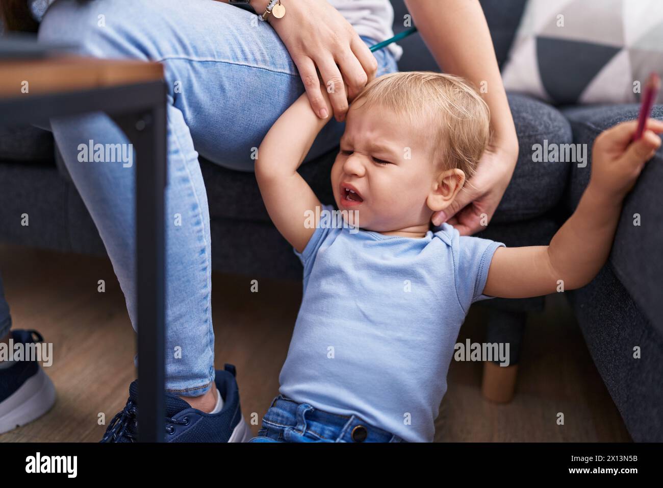 Mother and son crying on floor at home Stock Photo - Alamy