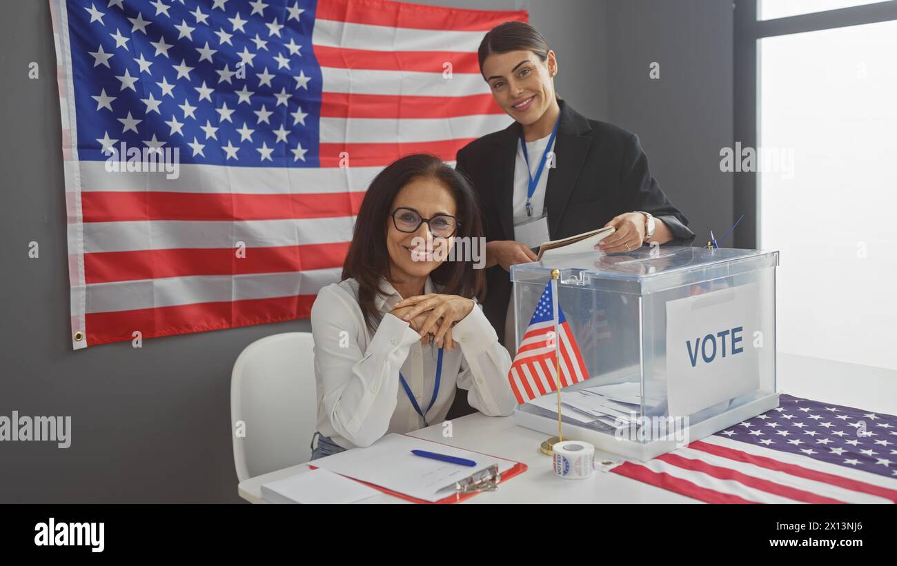 Two smiling women conducting electoral process in an american college ...