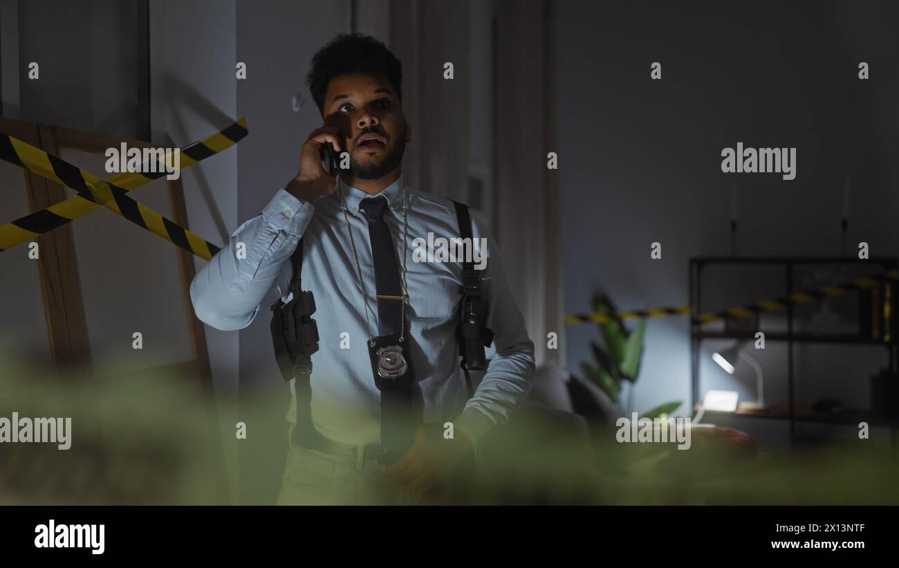 African american detective in a police station making a phone call ...
