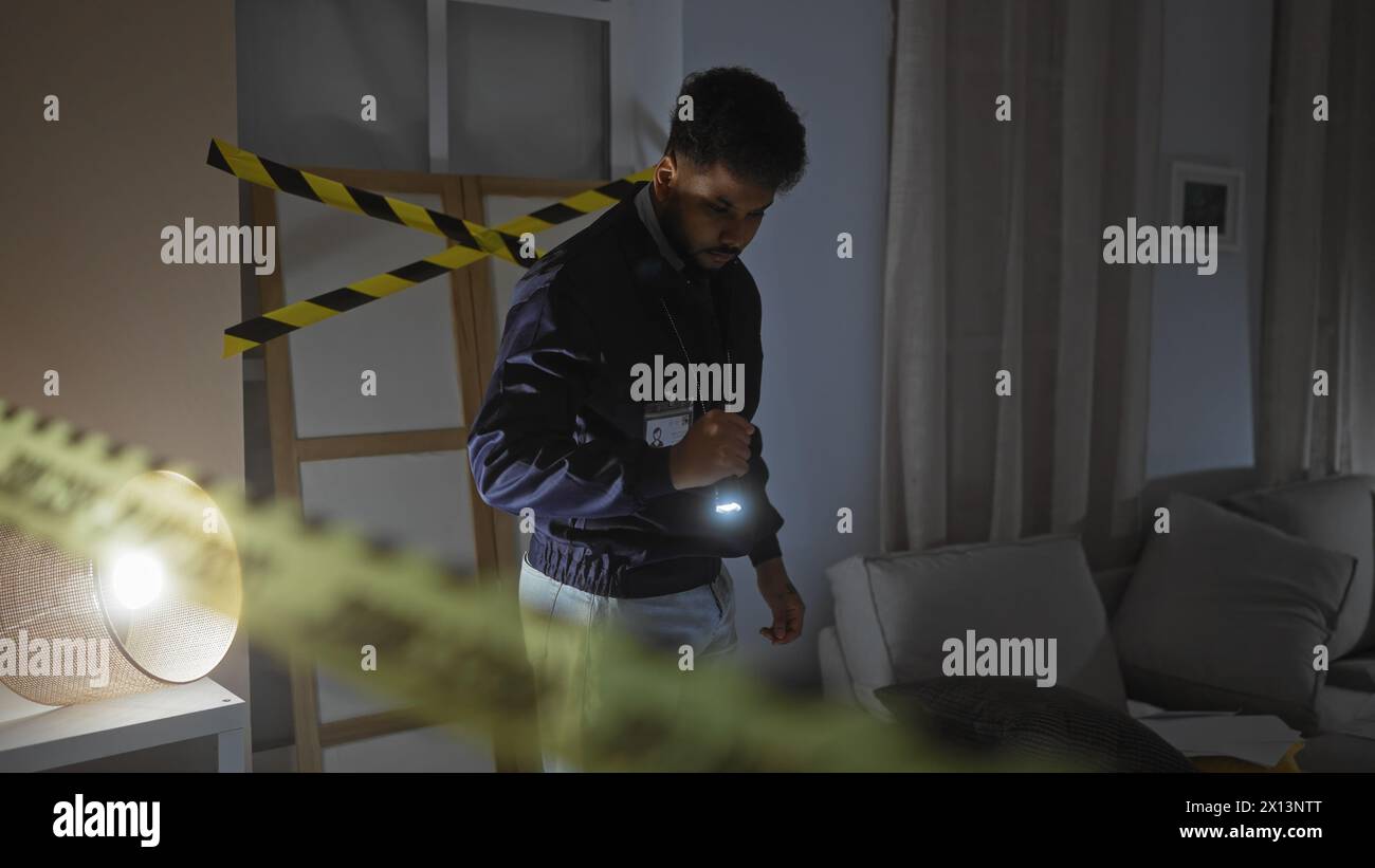 African american police detective investigating a crime scene indoors ...