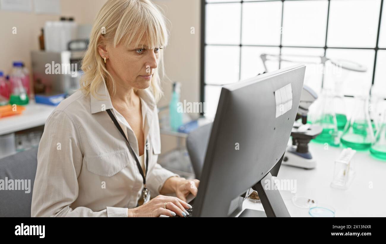 Concentrated woman scientist using computer in modern laboratory Stock ...