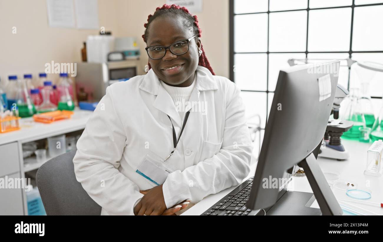 African american woman with braids working in a laboratory, smiling ...
