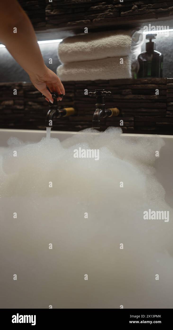 Hand faucet bath bubbles hi-res stock photography and images - Alamy