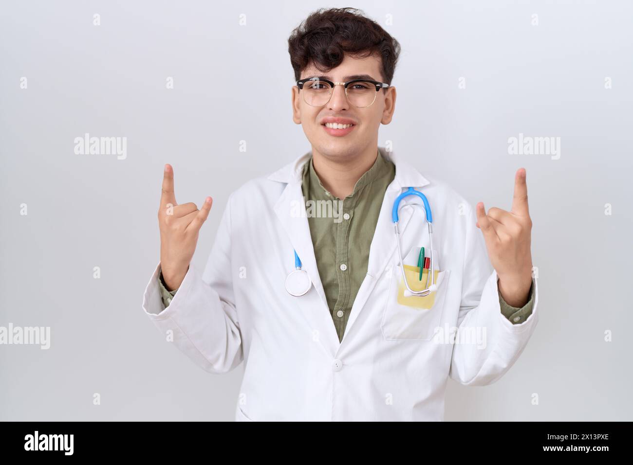 Young non binary man wearing doctor uniform and stethoscope shouting ...