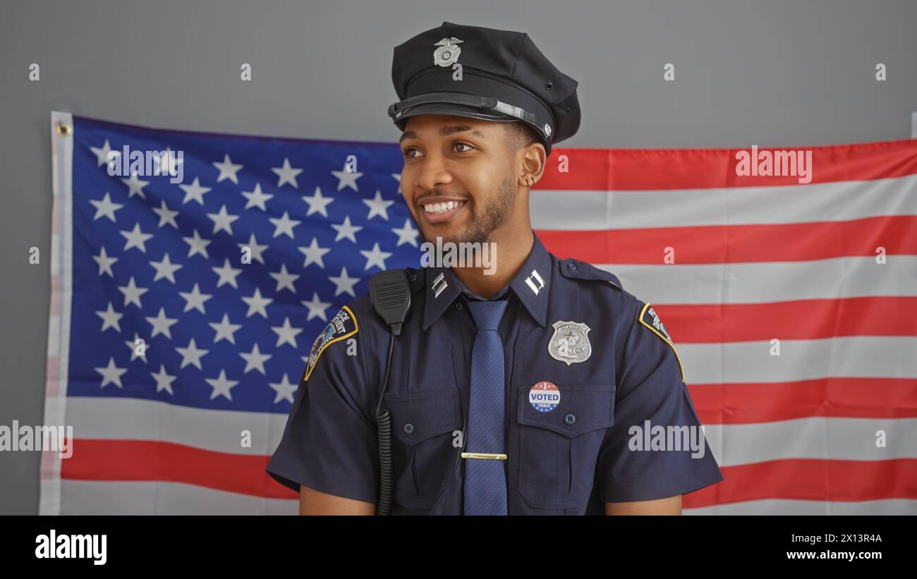 Handsome african american police officer smiles proudly in front of a ...