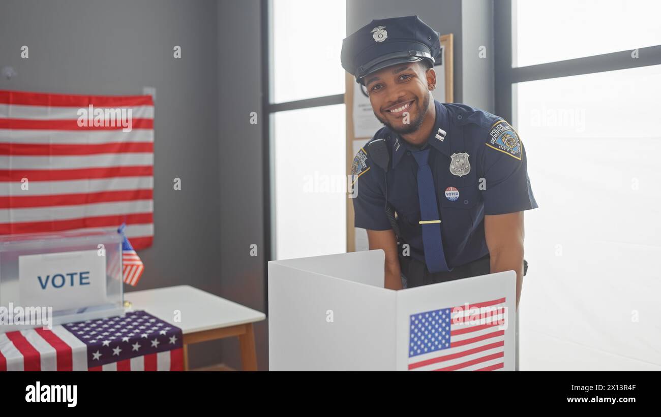A smiling african american male police officer stands by a voting booth ...