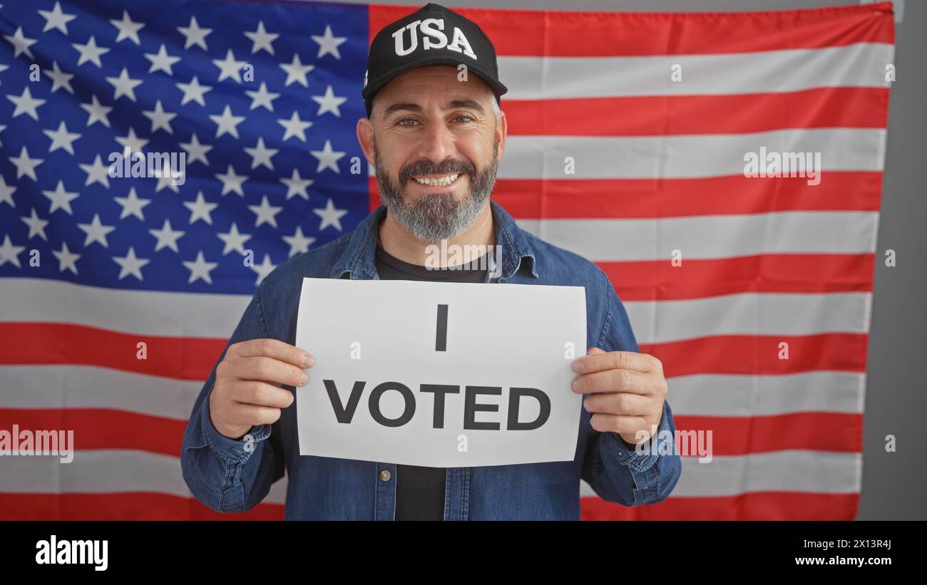 A bearded man in a usa cap holding an 'i voted' sign against an ...