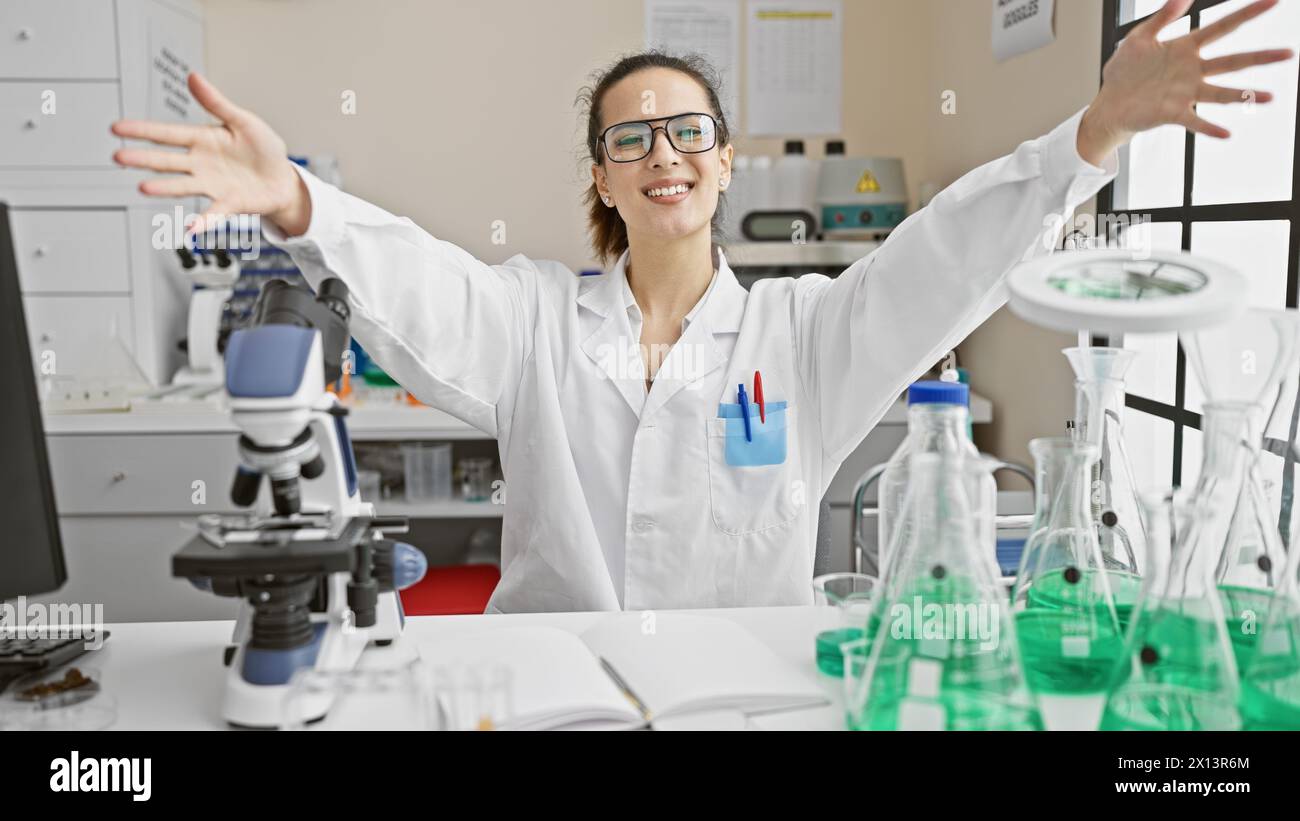 Happy scientist woman celebrating success in lab filled with glassware ...