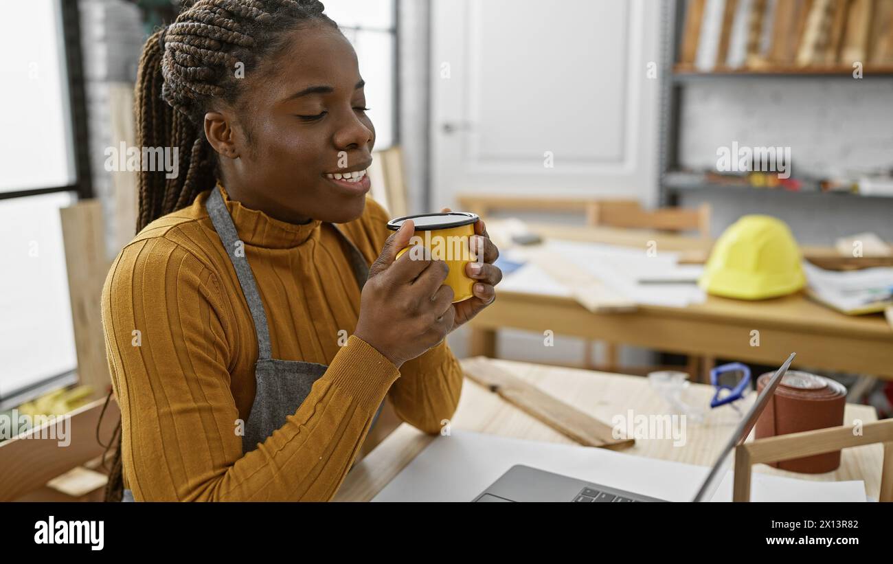 African american woman with braids enjoying a coffee break at her ...