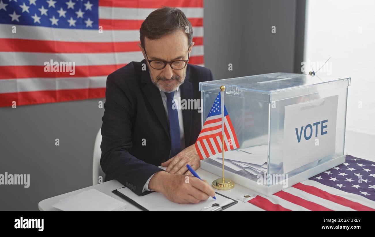 Middle-aged man voting in an american election indoors with a us flag ...