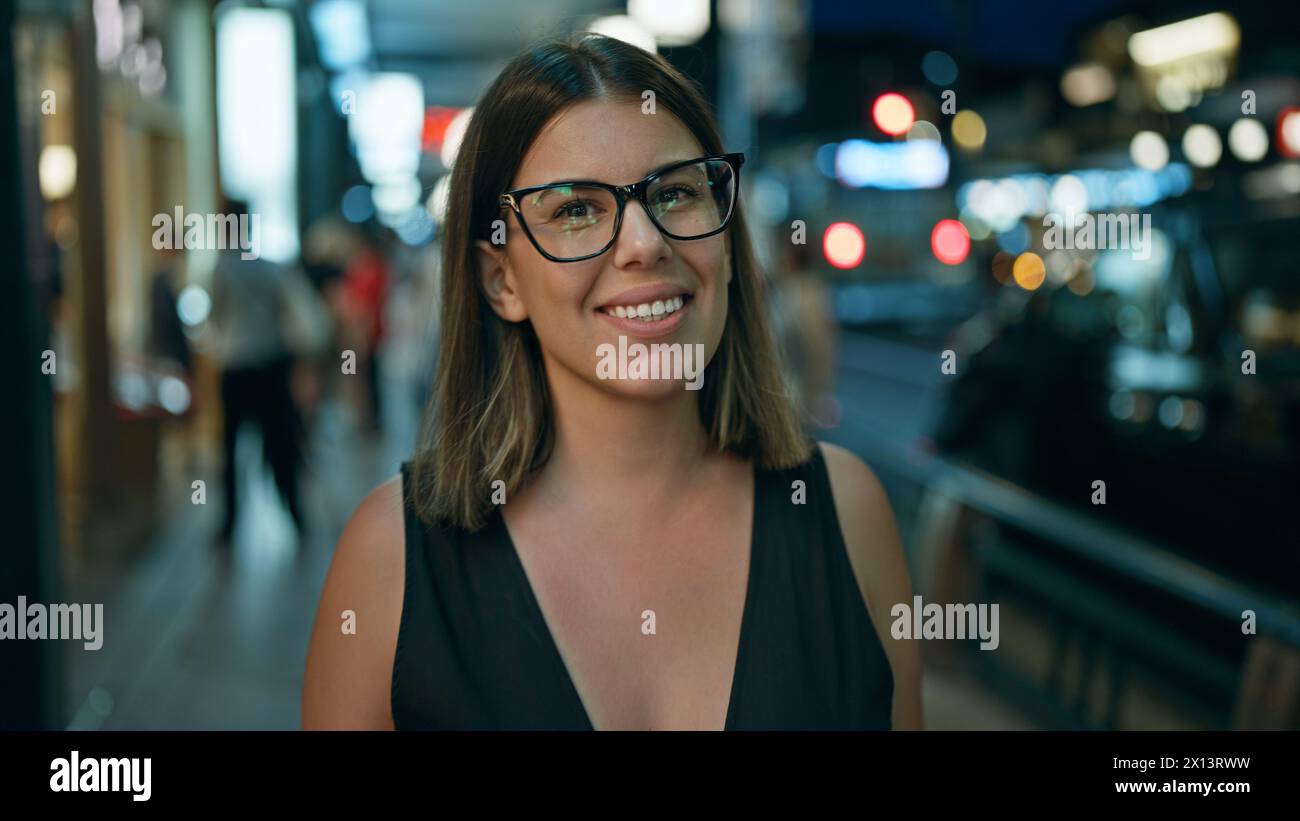 Laughing out loud, a confident beautiful hispanic woman wearing glasses ...