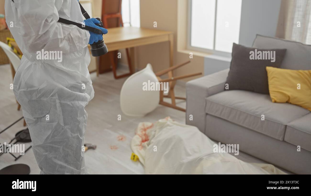 Forensic expert in protective suit examining crime scene with camera in ...