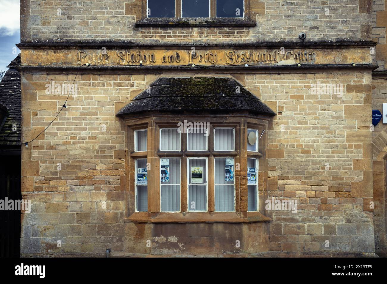 A charming old stone sign above the window of Stow on the Wold police ...