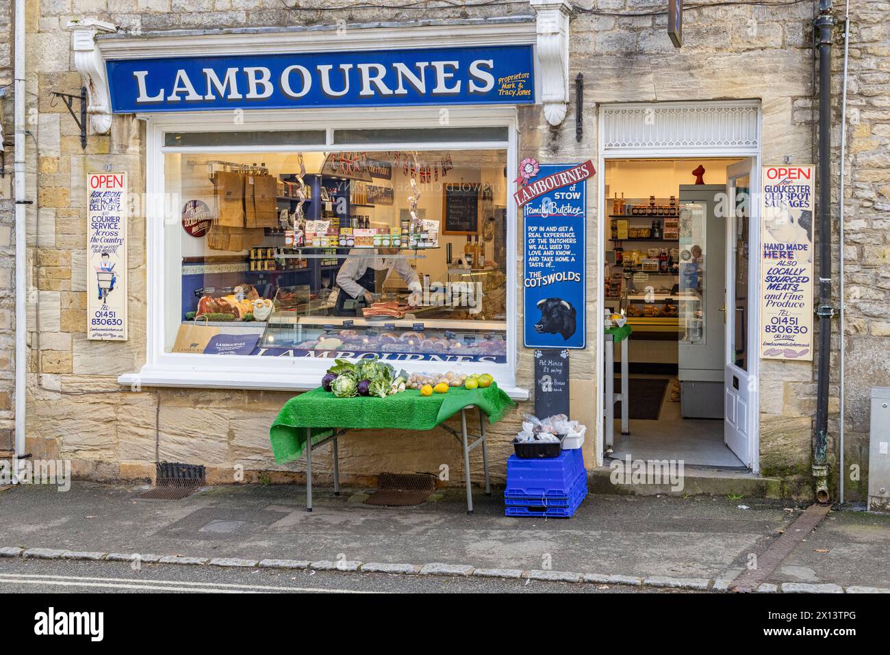 A skilled butcher at work in a small, family run butchers shop ...