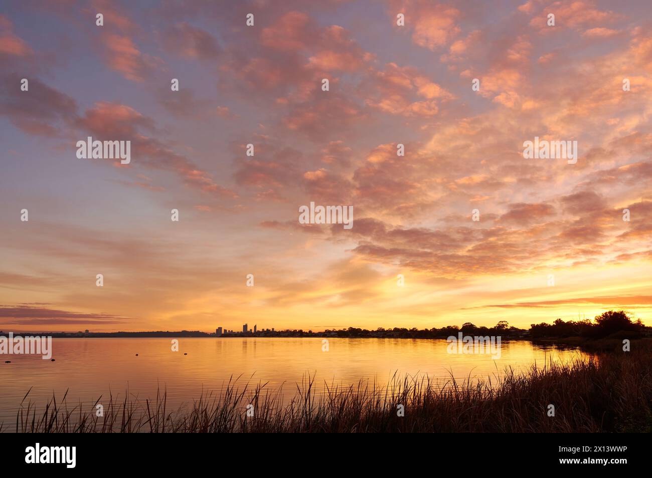 A colourful sunrise at the Attadale foreshore on the Swan River with ...
