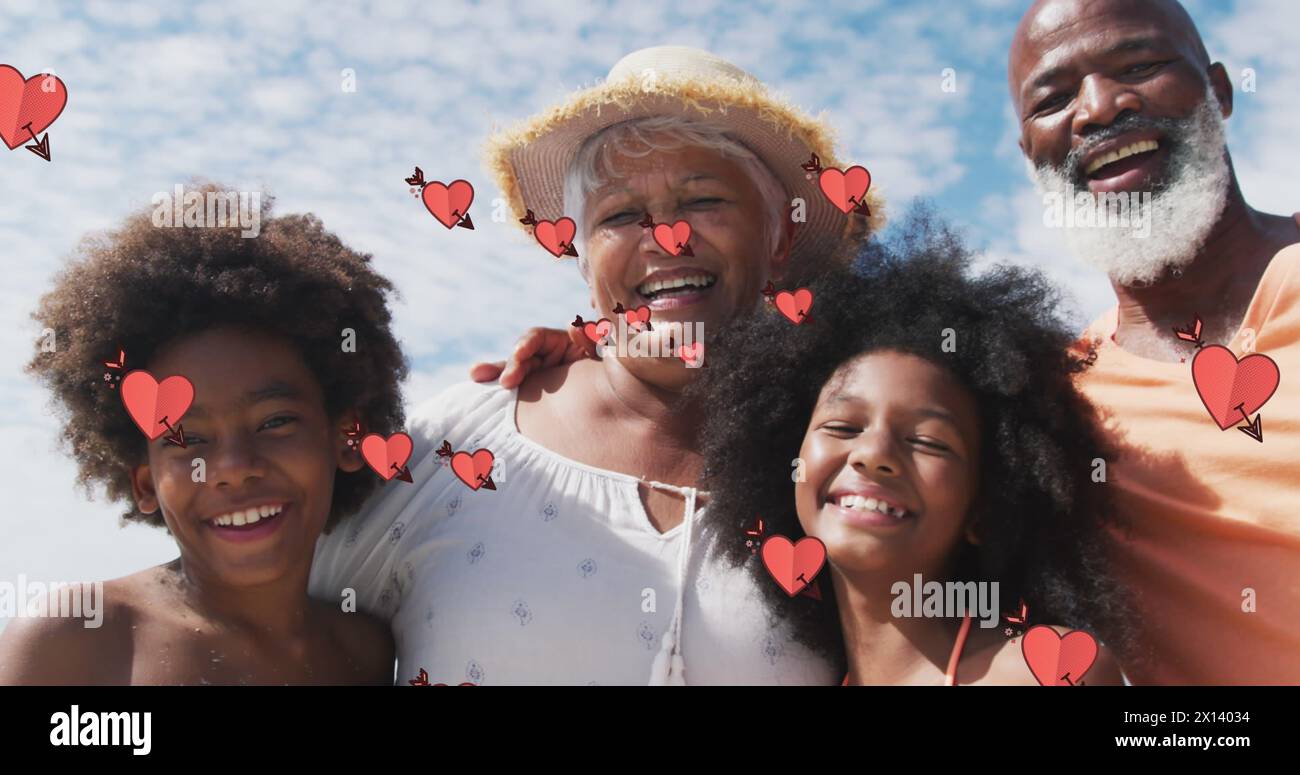 Image of hearts over smiling african american family smiling and ...