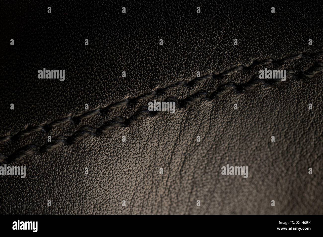a black leather object sewn from several parts, part of a shoe made of ...