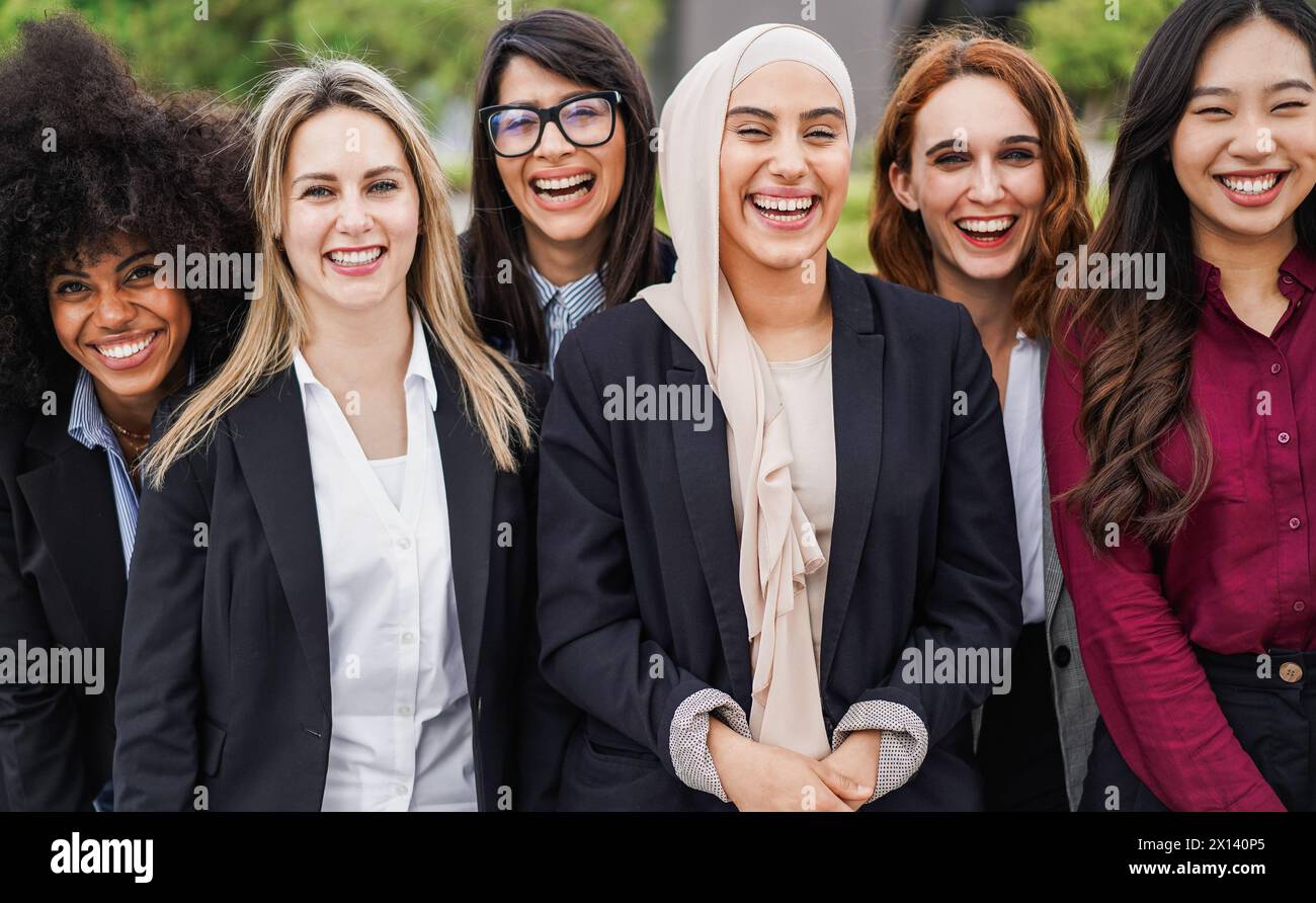 Multiethnic business women colleagues smiling on camera outdoor - Diversity and female expertise ...