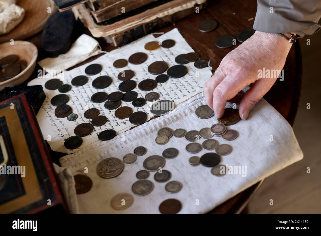 A selection of old British coins on a table at the Weald & Downland ...