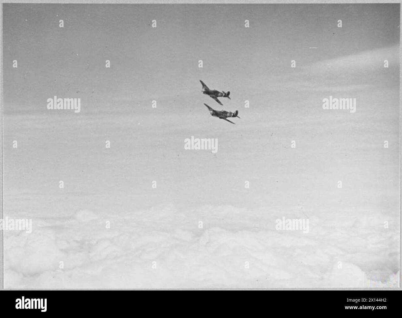 Two Tomahawk aircraft fly above clouds, illustrating operational ...
