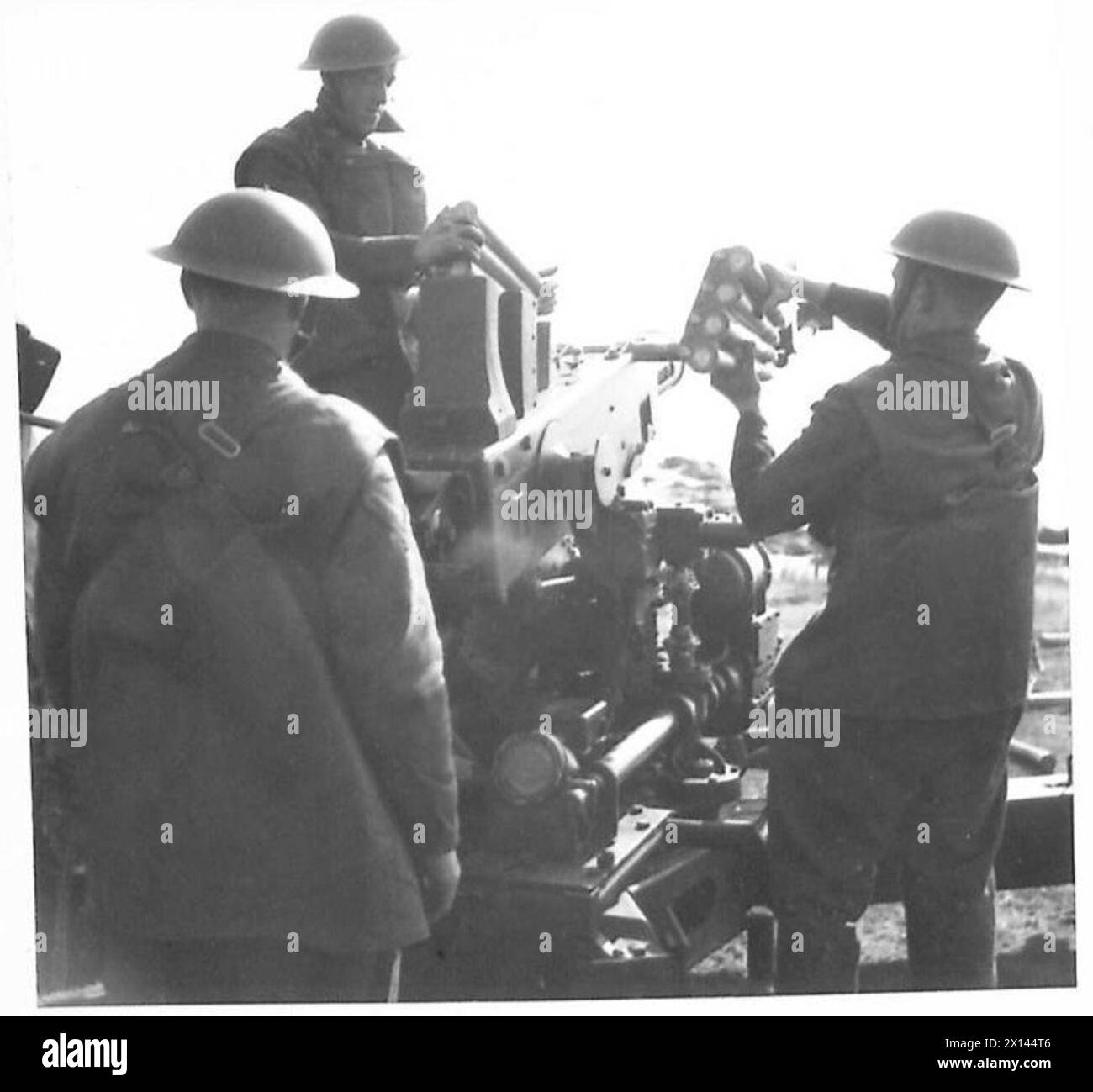 Personnel load a Bofors anti-aircraft gun during training exercises ...