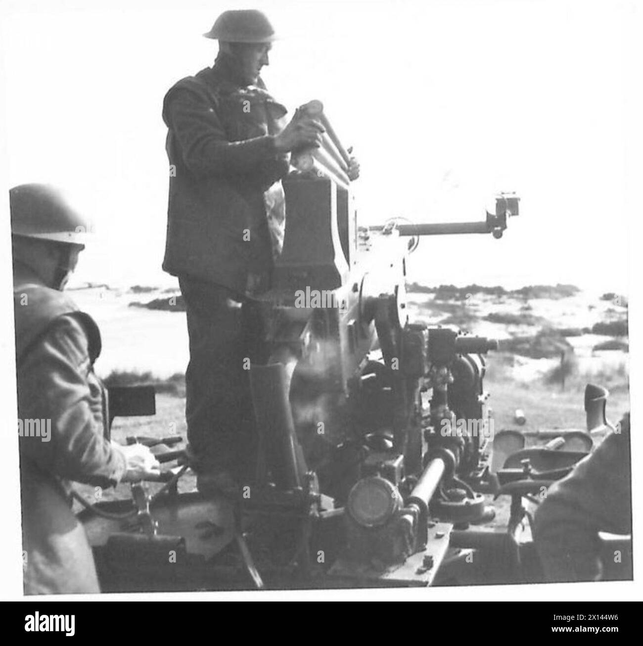 Gun crew members reload a Bofors anti-aircraft gun during A.A. training ...