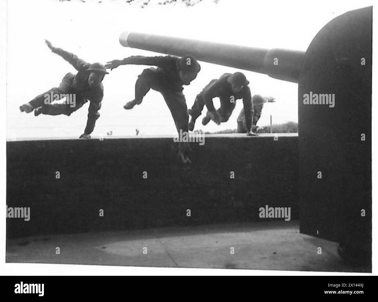 The gun crew aboard HMS Hood leap over the parapet to man their gun ...