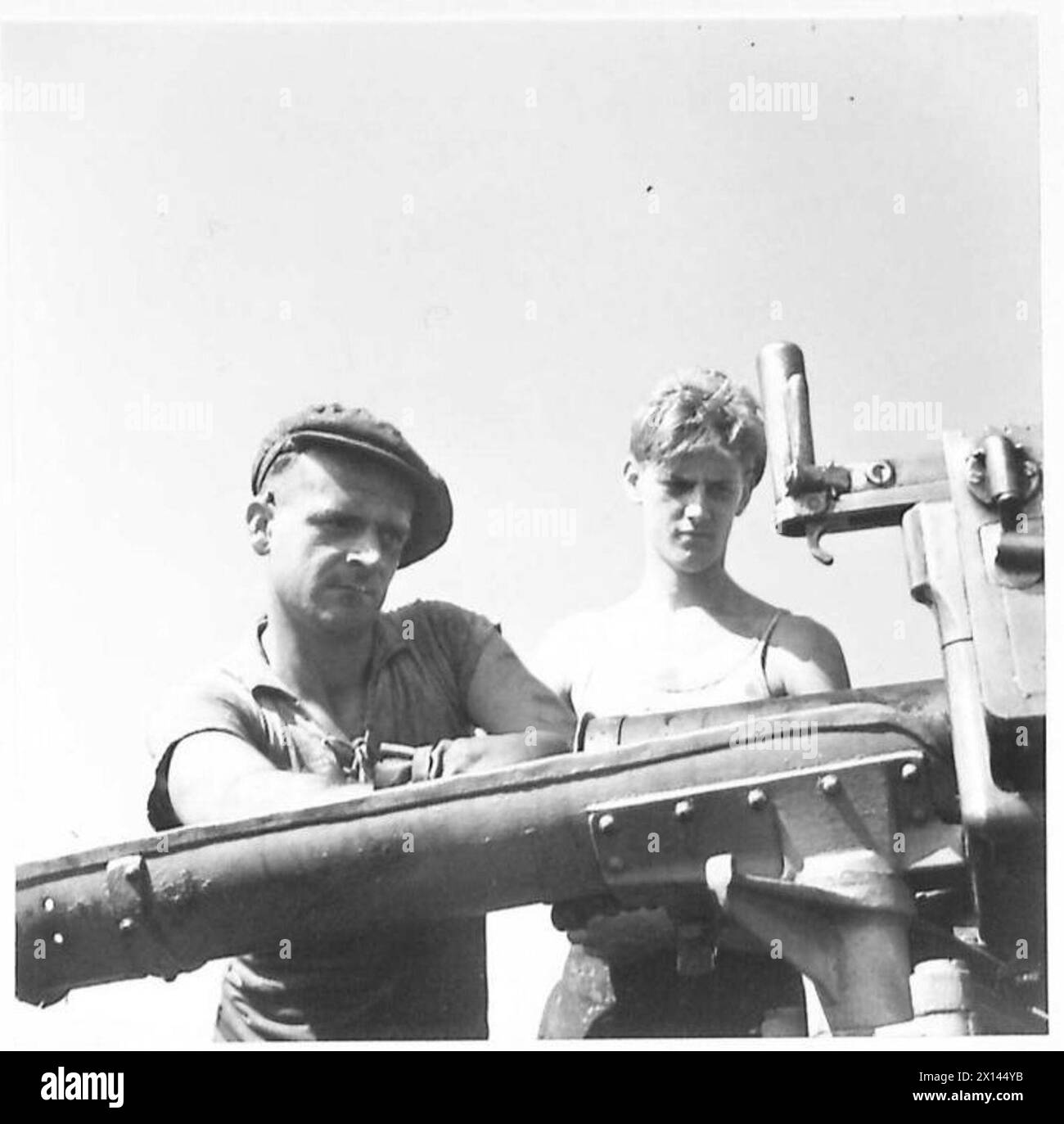 A merchant seaman operates as a loader on a ship's gun while delivering ...