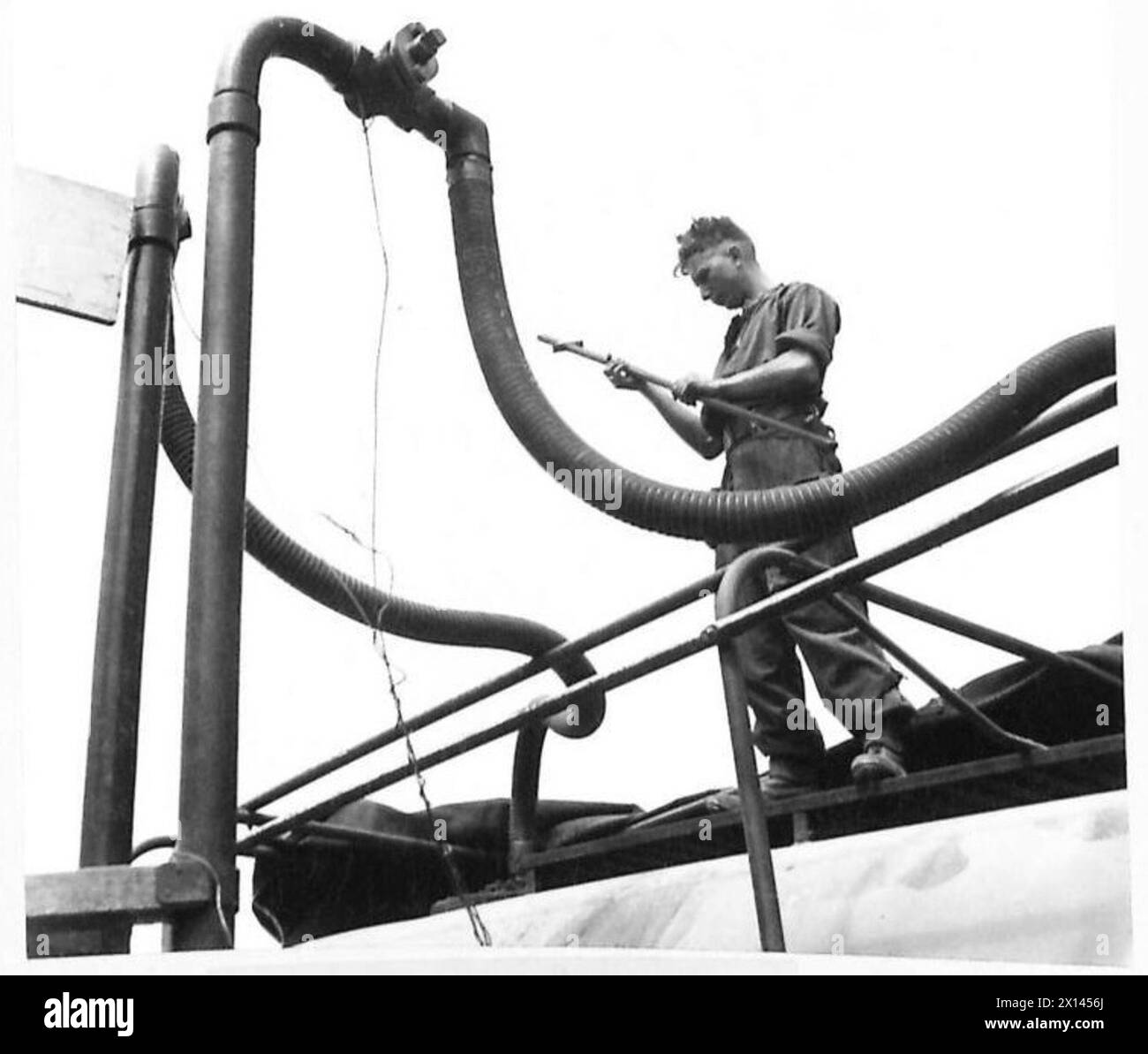 SECOND FRONT PETROL PIPE LINE - As the tankers fill up one of the men ...