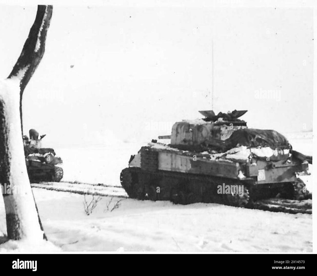 BRITISH ATTACK NEAR HEINSBERG - Tanks moving up as enemy shells burst ...