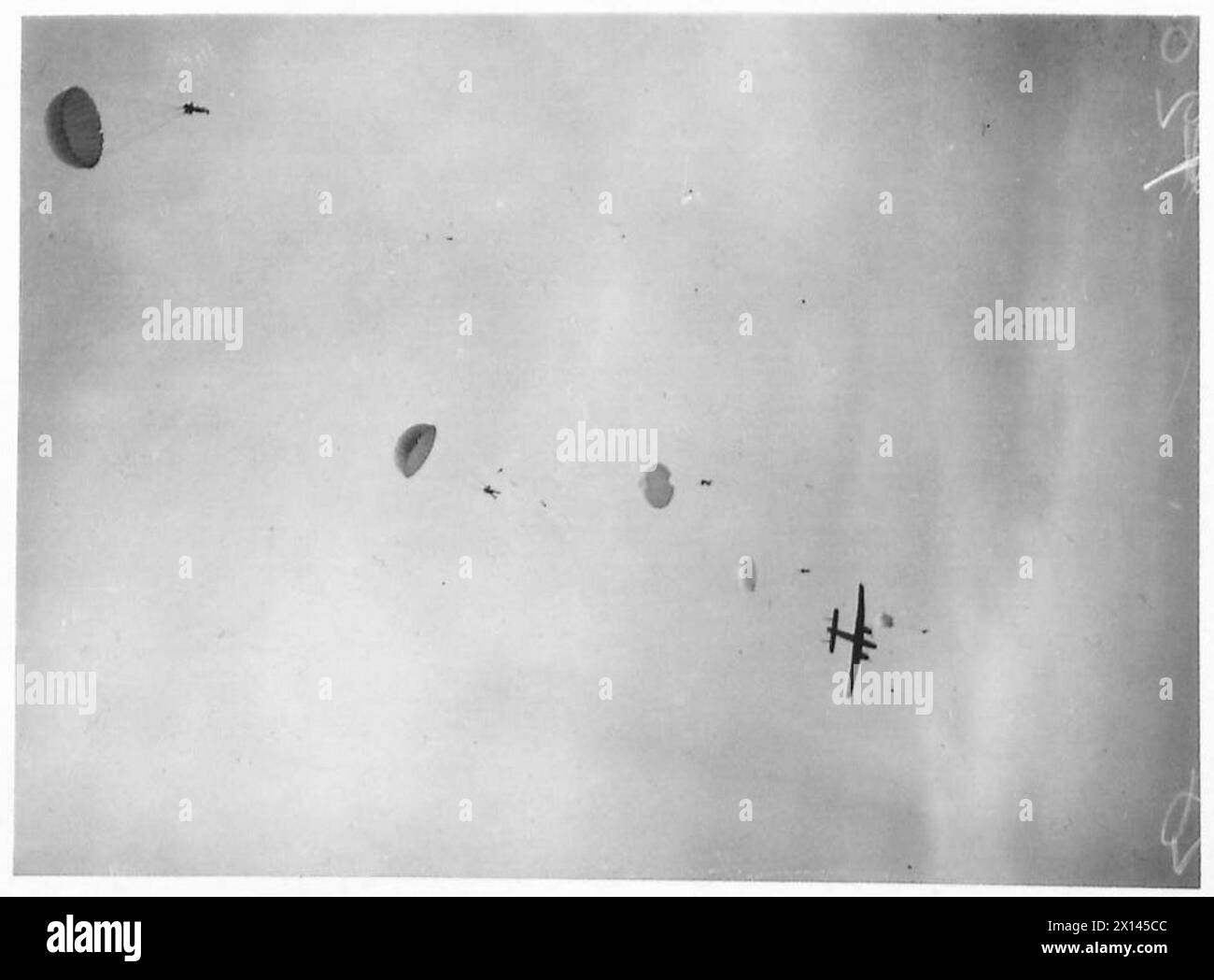 Parachute troops are deployed from aircraft during a large-scale ...