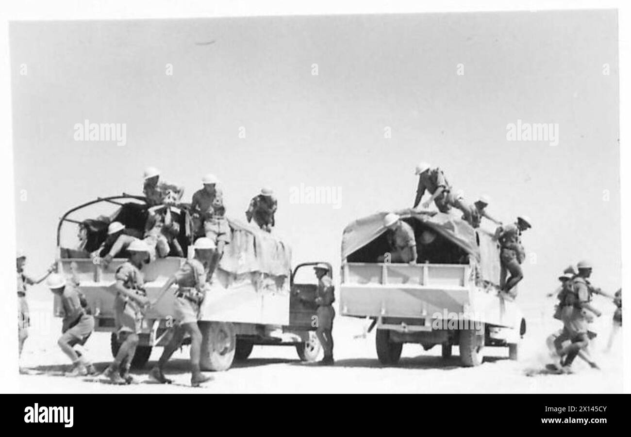 British Army soldiers disembark from lorries upon arrival at the sea ...