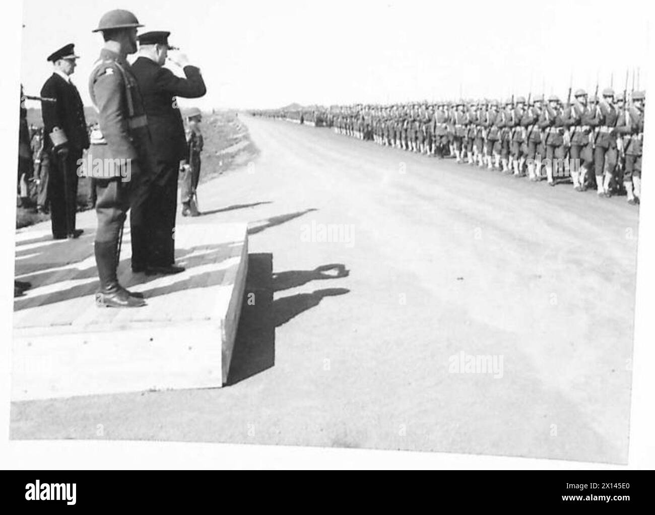 The Prime Minister salutes American troops marching past during a visit ...