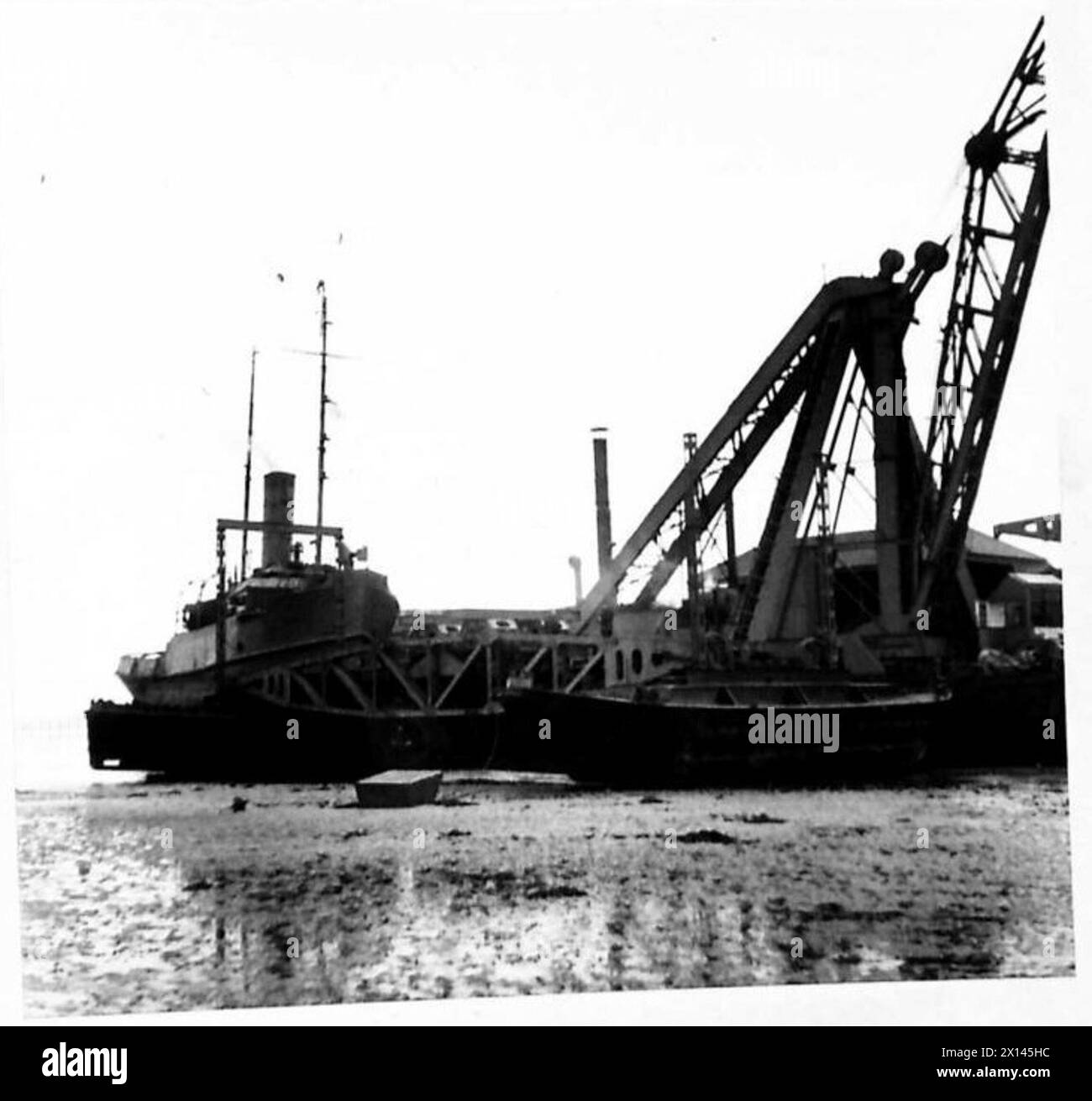 A floating pier section on steel pontoons is deployed at low water for ...