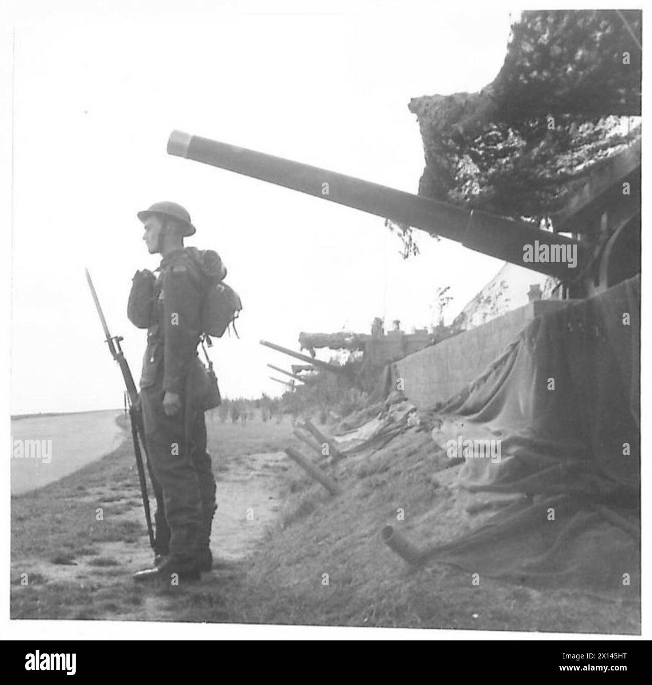 HMS HOOD FIGHTS ON - A sentry standing guard under four barrels of this ...