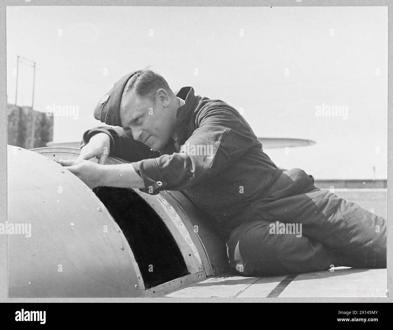 An RAF fitter is working on a Meteor twin-jet aircraft at a Royal Air ...
