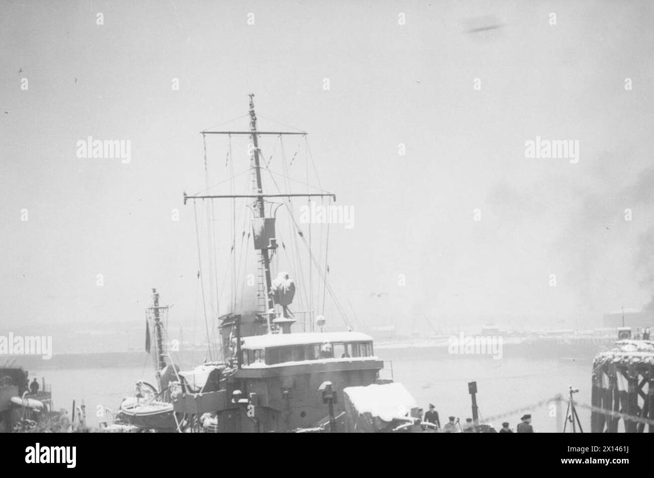HMS Beaumaris, a snow-covered minesweeper, is in harbour at Rosyth ...