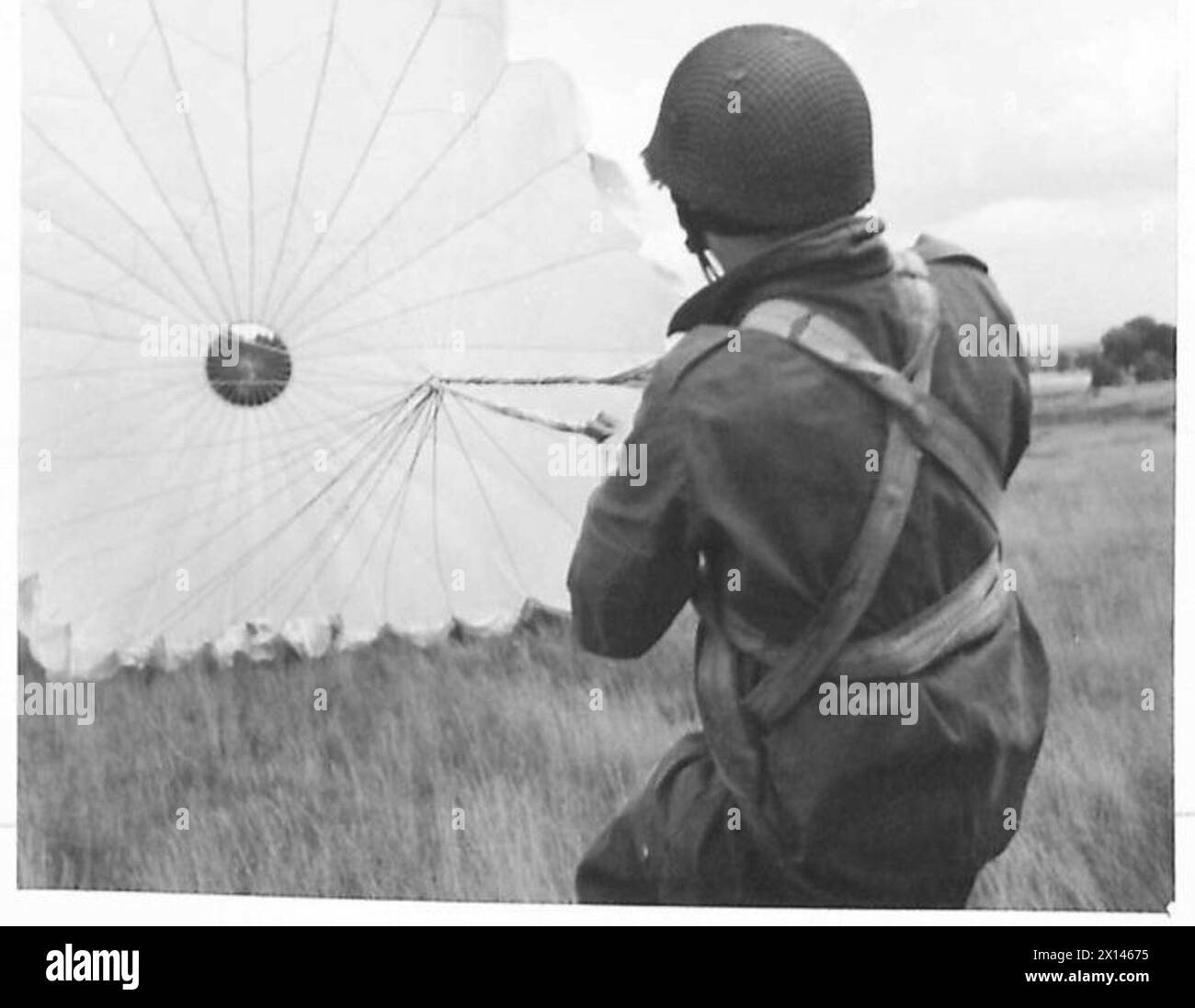 PARATROOPS IN TRAINING - Paratroops controlling their 'chutes after a ...
