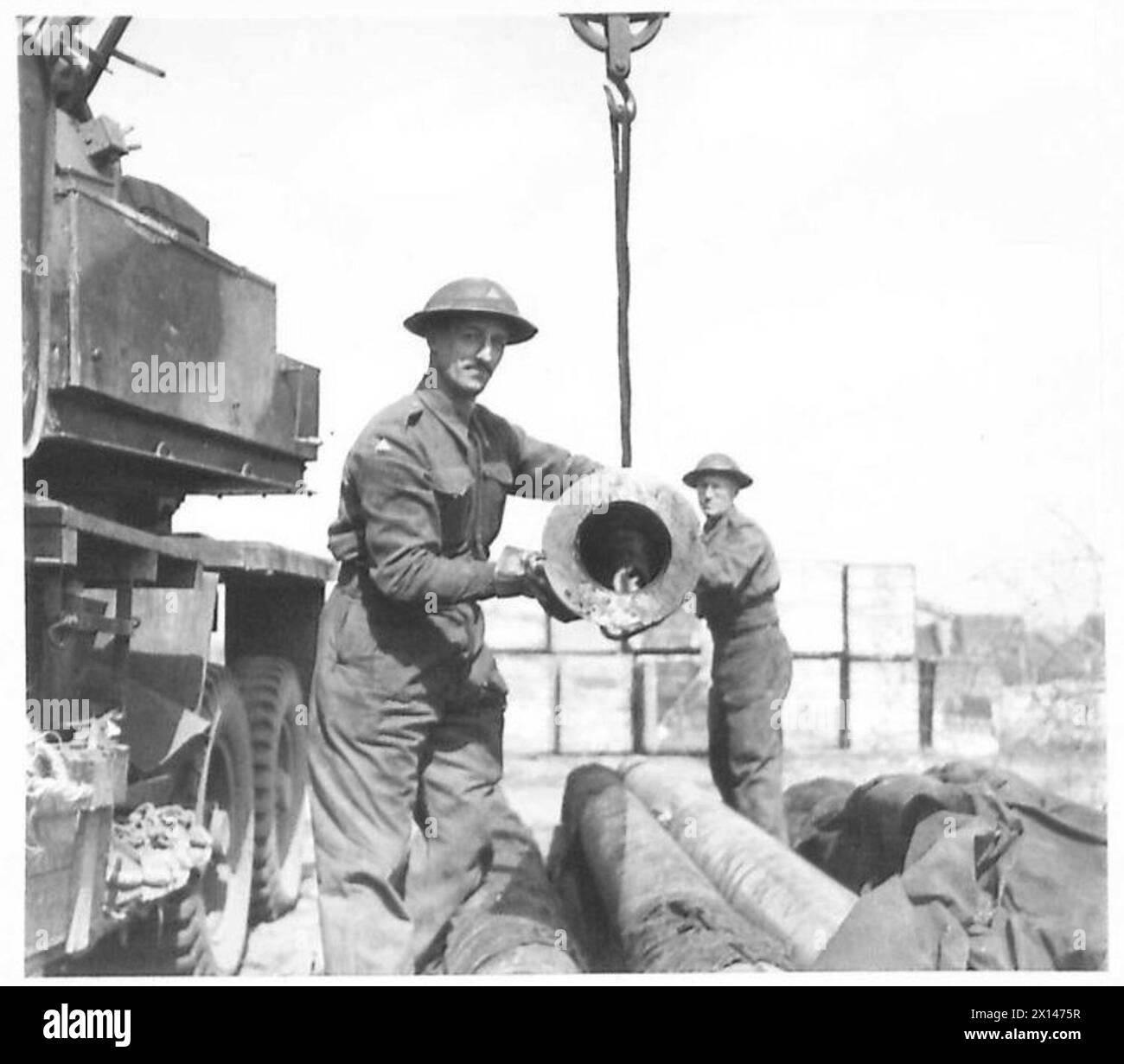 5.5-inch artillery gun barrels are being unloaded at the 1st Battalion ...