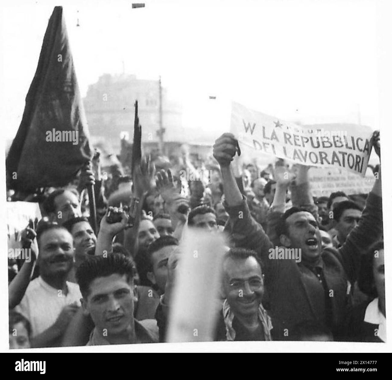 A civilian holding a Communist slogan during the presence of British ...