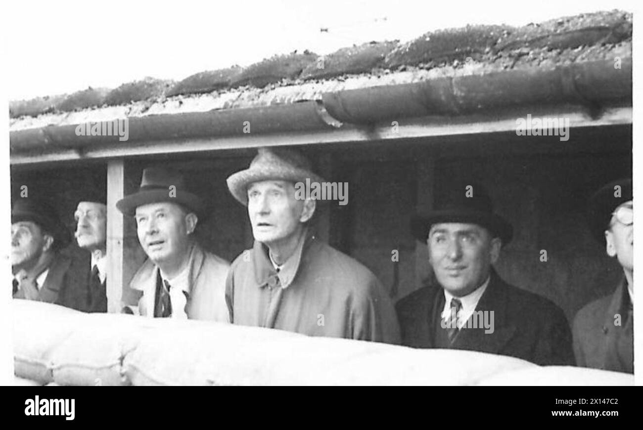 MPs Noel Goldie, Stanley Reed, and Dan Franklon observe rockets being ...