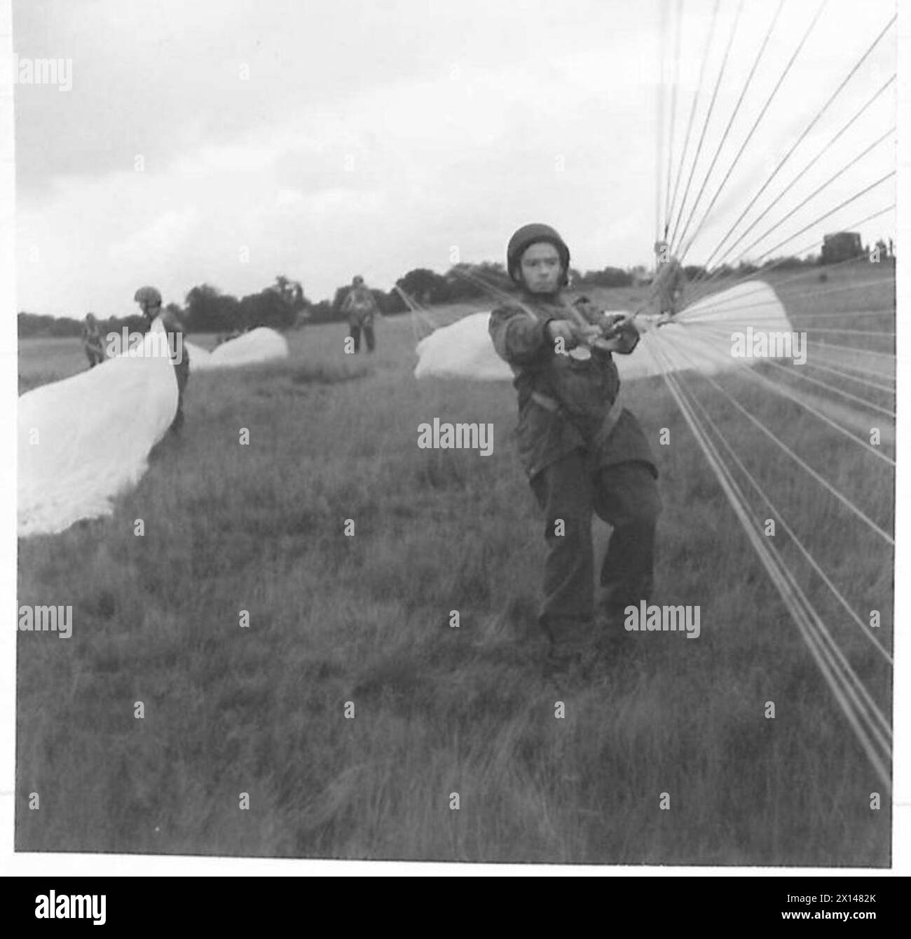 A paratroop is shown controlling a parachute before releasing from the ...