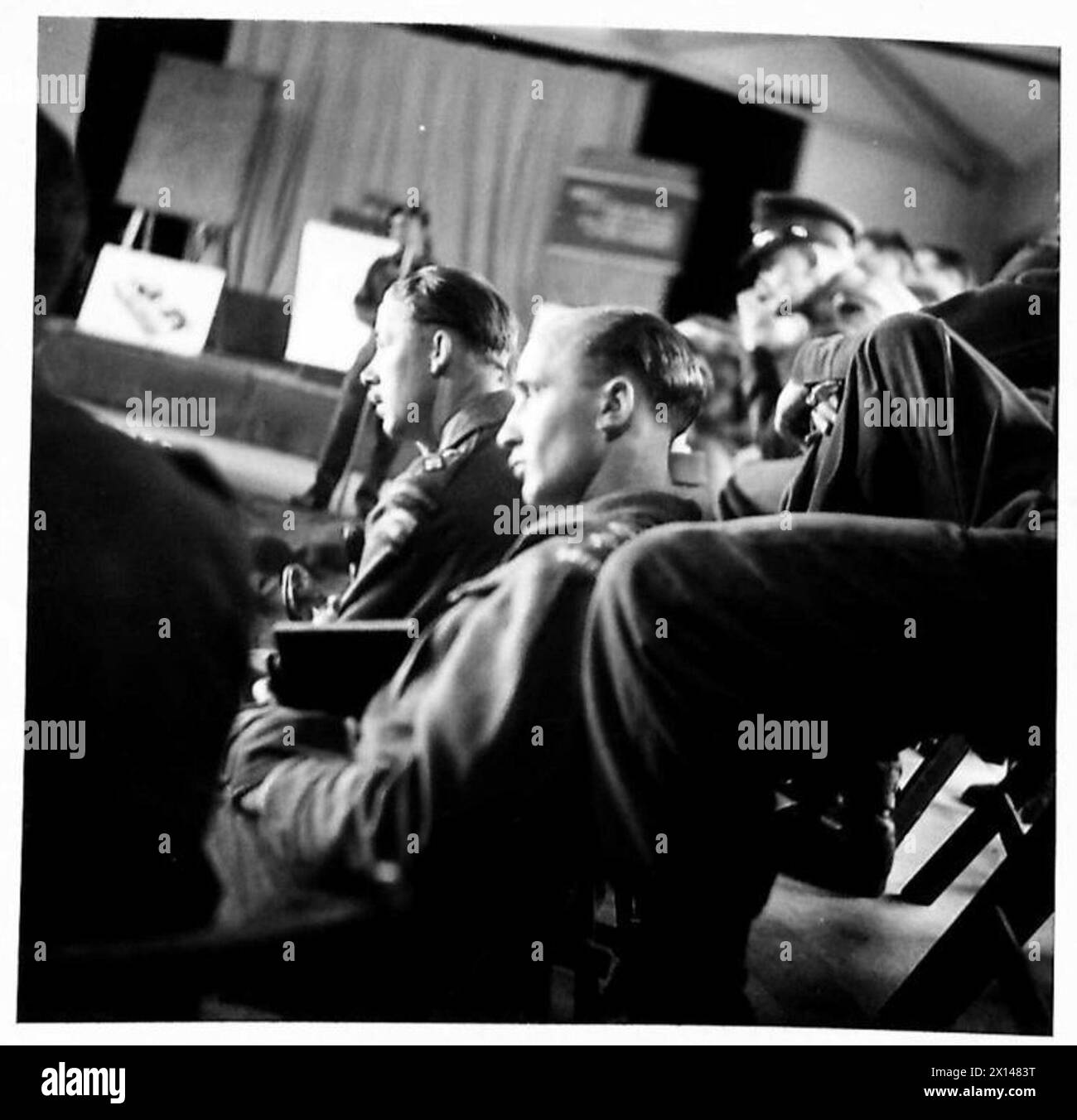 Officers attending an infantry school are shown during lectures ...