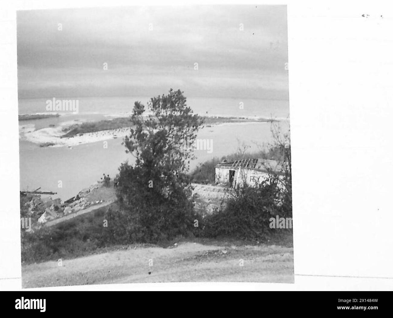 The demolished bridge over the Sangro River is shown from the riverbank ...