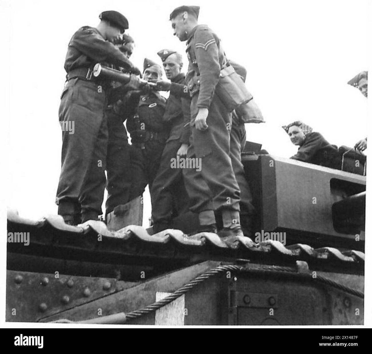 ARMY TANK BRIGADE DEMONSTRATION - Troops examining a 6-pounder shell on ...